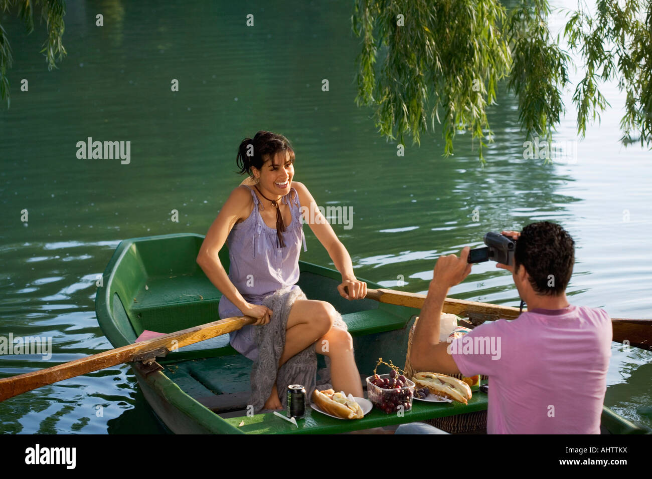 Man filming a woman on boat Stock Photo - Alamy