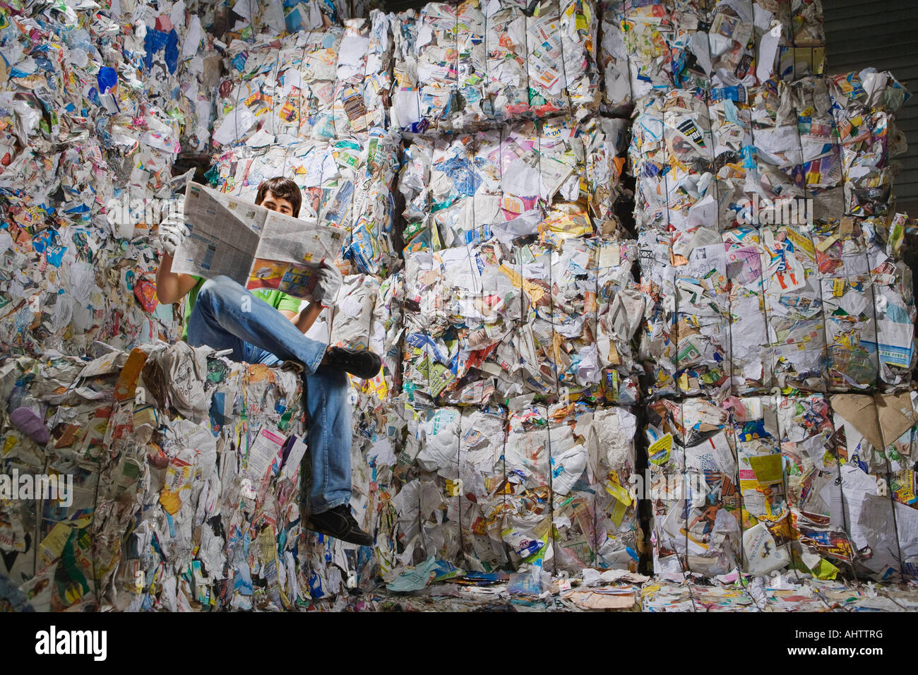 Man reading a paper at a recycling plant Stock Photo - Alamy