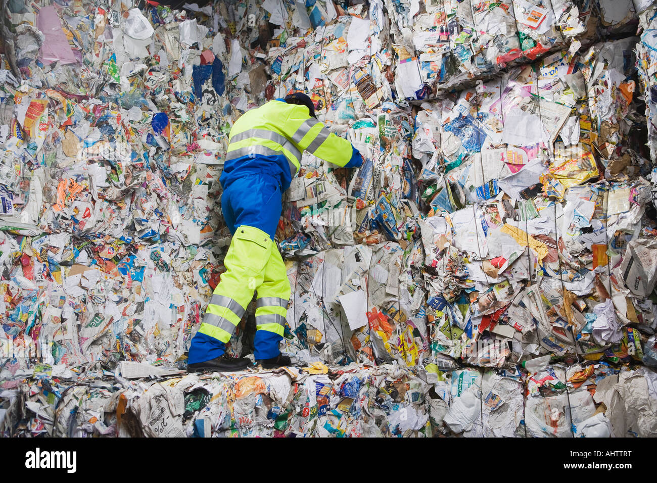 Man leaning on wall of recycling Stock Photo - Alamy