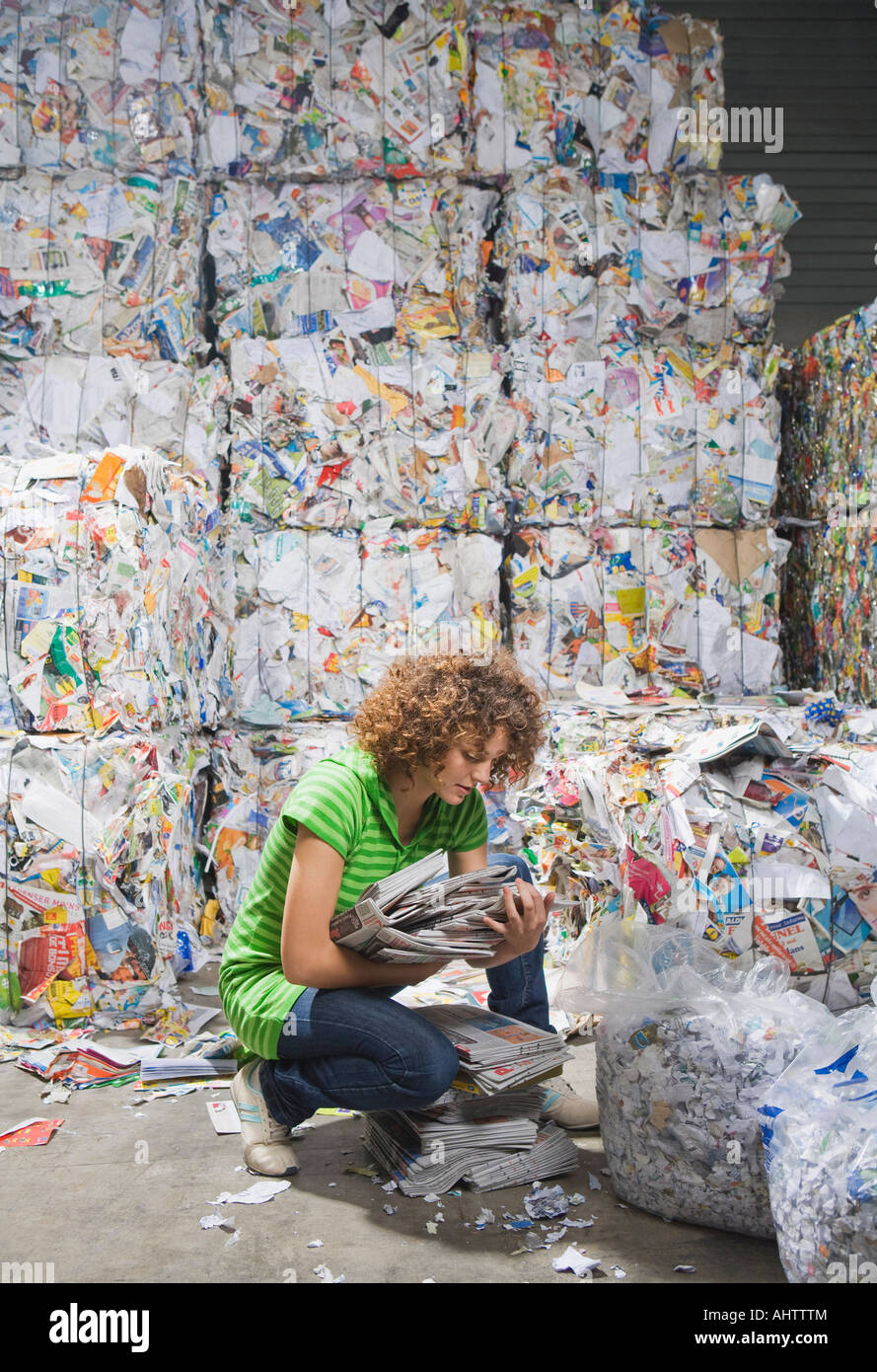 Woman sorting through papers at a recycling plant Stock Photo - Alamy