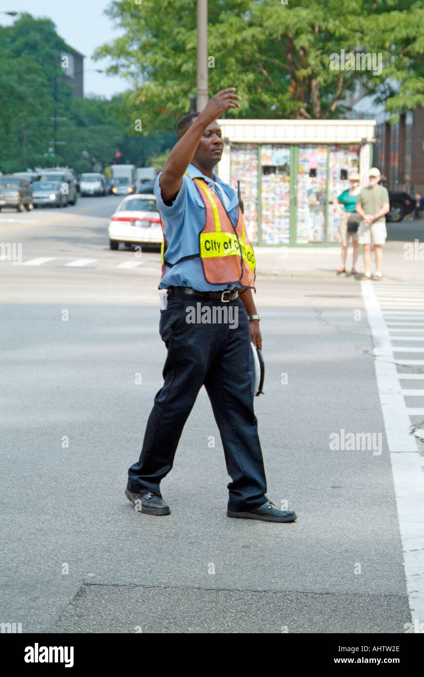 Traffic police direct pedestrian and automobile traffic in busy ...