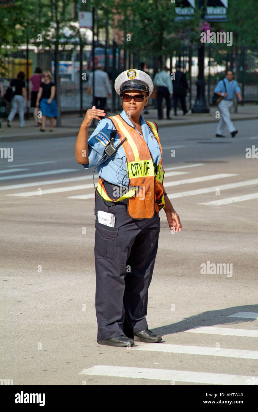 Traffic police direct pedestrian and automobile traffic in busy ...