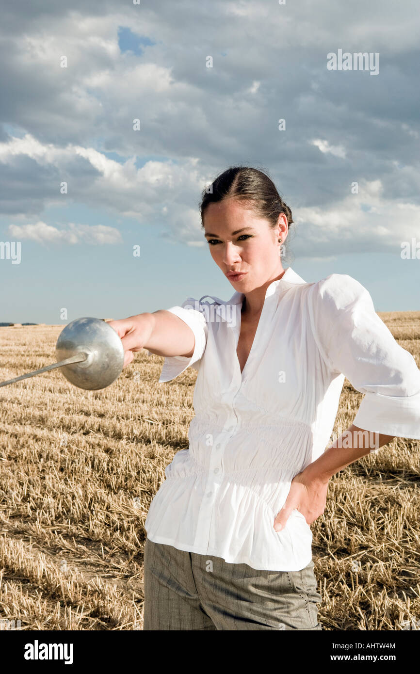 Woman pointing sword in wheat field Stock Photo - Alamy