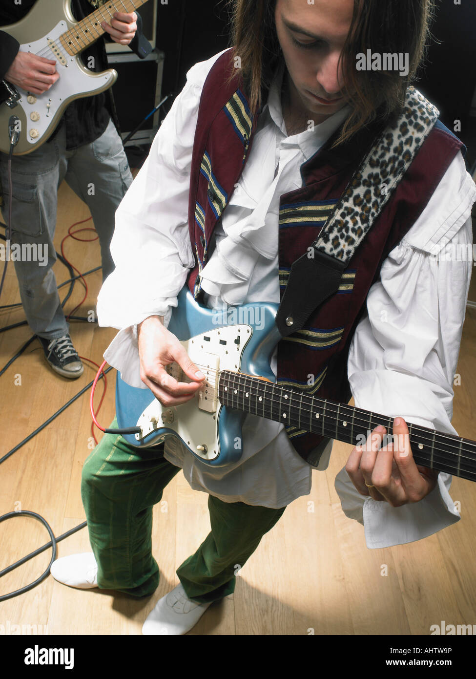 Two electric guitar players in studio Stock Photo - Alamy