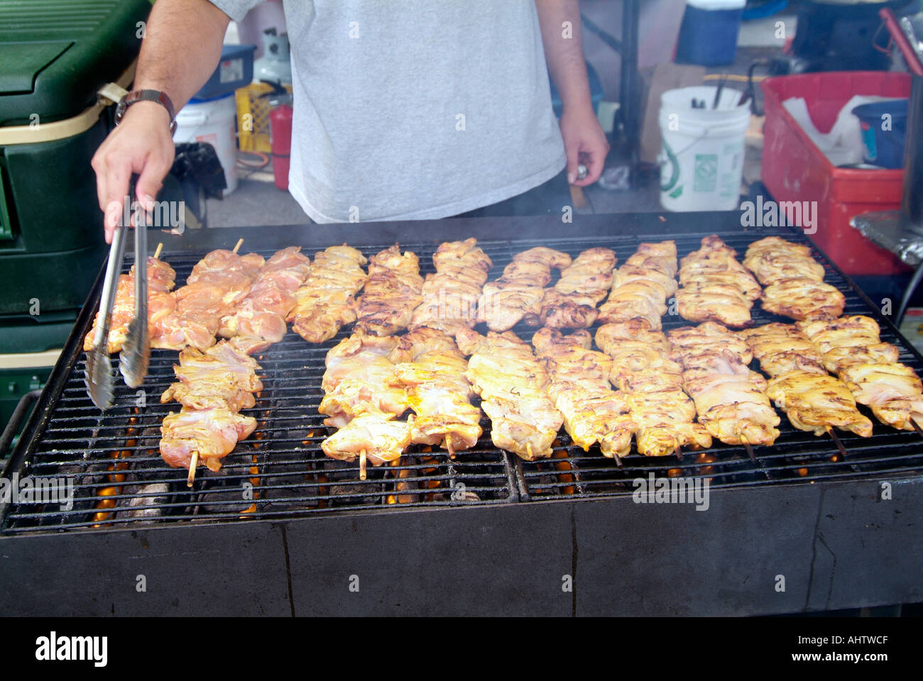 Chicken cooking on an open grill Stock Photo - Alamy