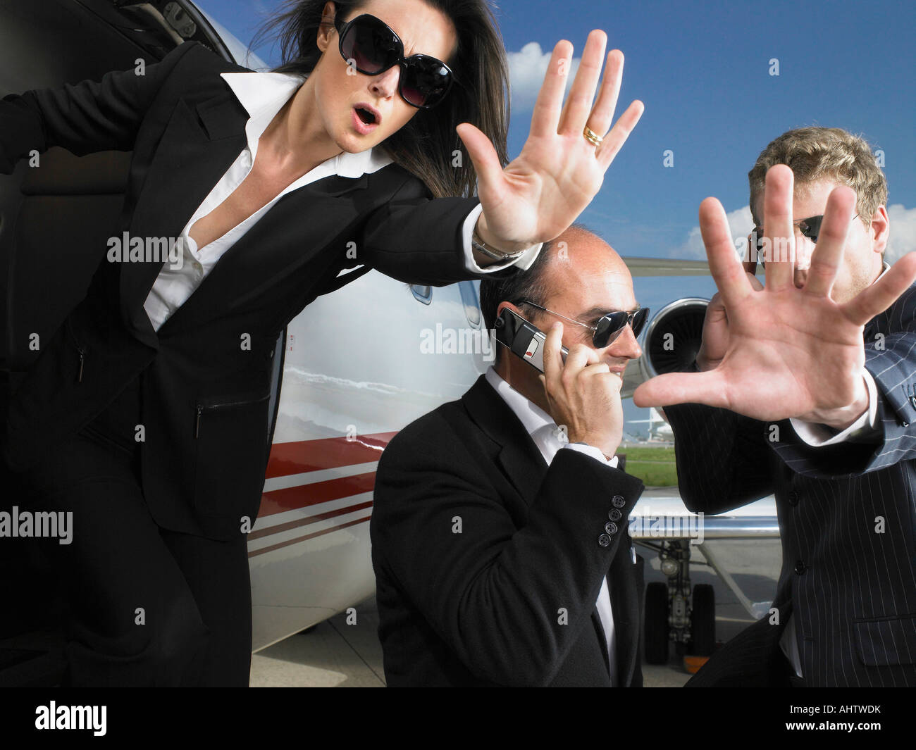 Two bodyguards defending businessman while exiting jet Stock Photo - Alamy