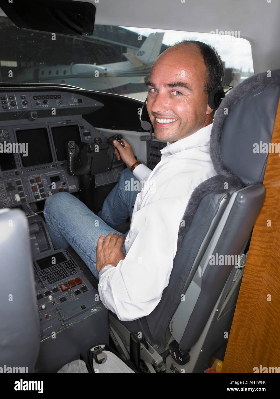 Male pilot in cockpit of private jet Stock Photo - Alamy