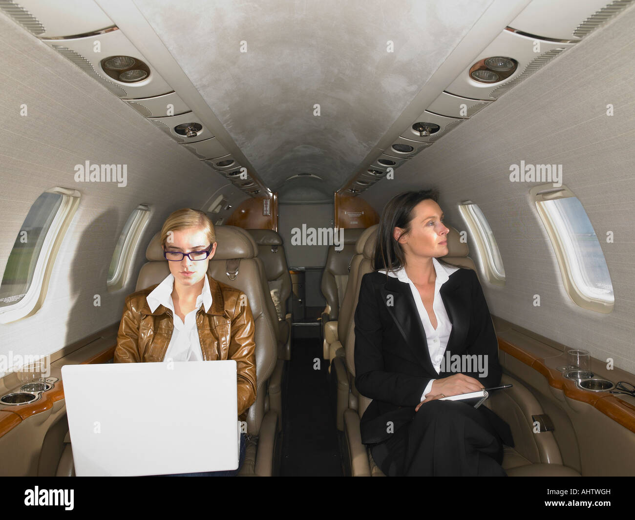 Two women in a private jet Stock Photo - Alamy