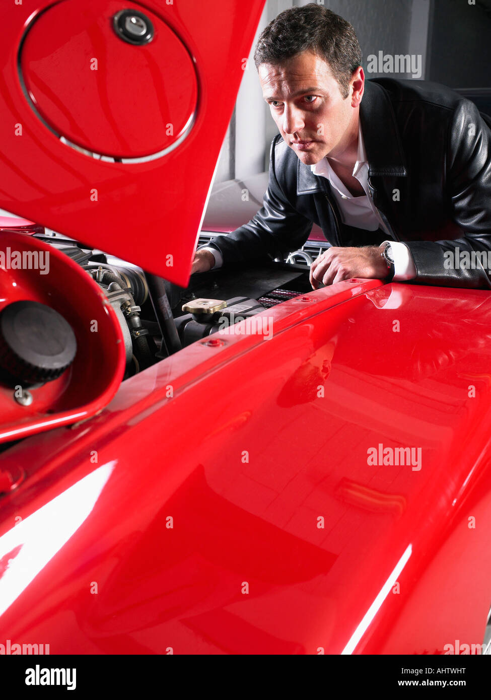 Man watching a V12 motor in a Ferrari Stock Photo - Alamy
