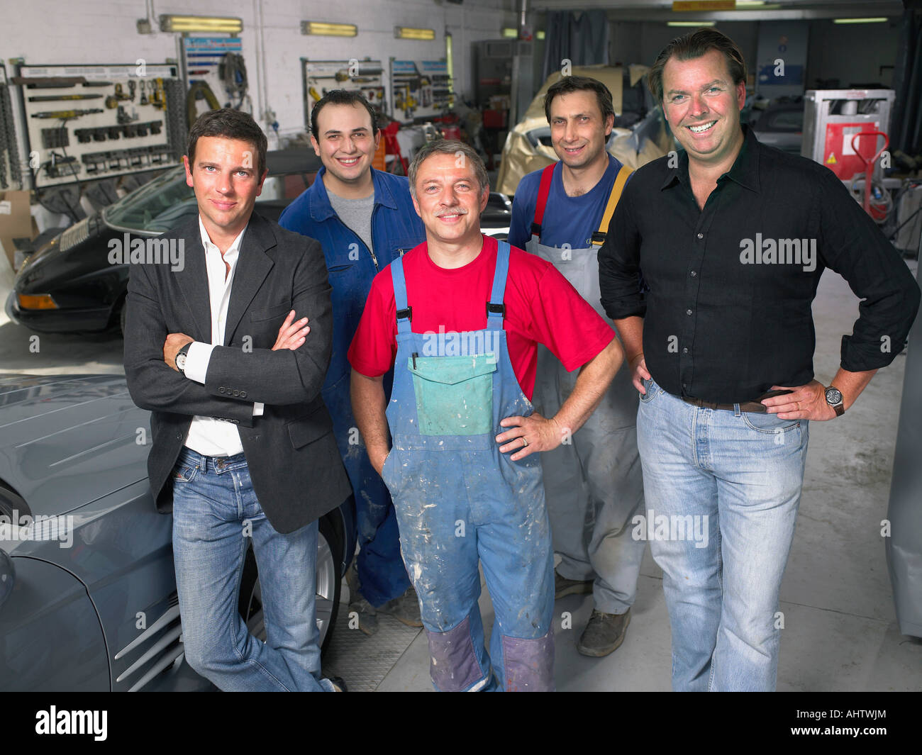 Group of workers and bosses in a garage Stock Photo - Alamy