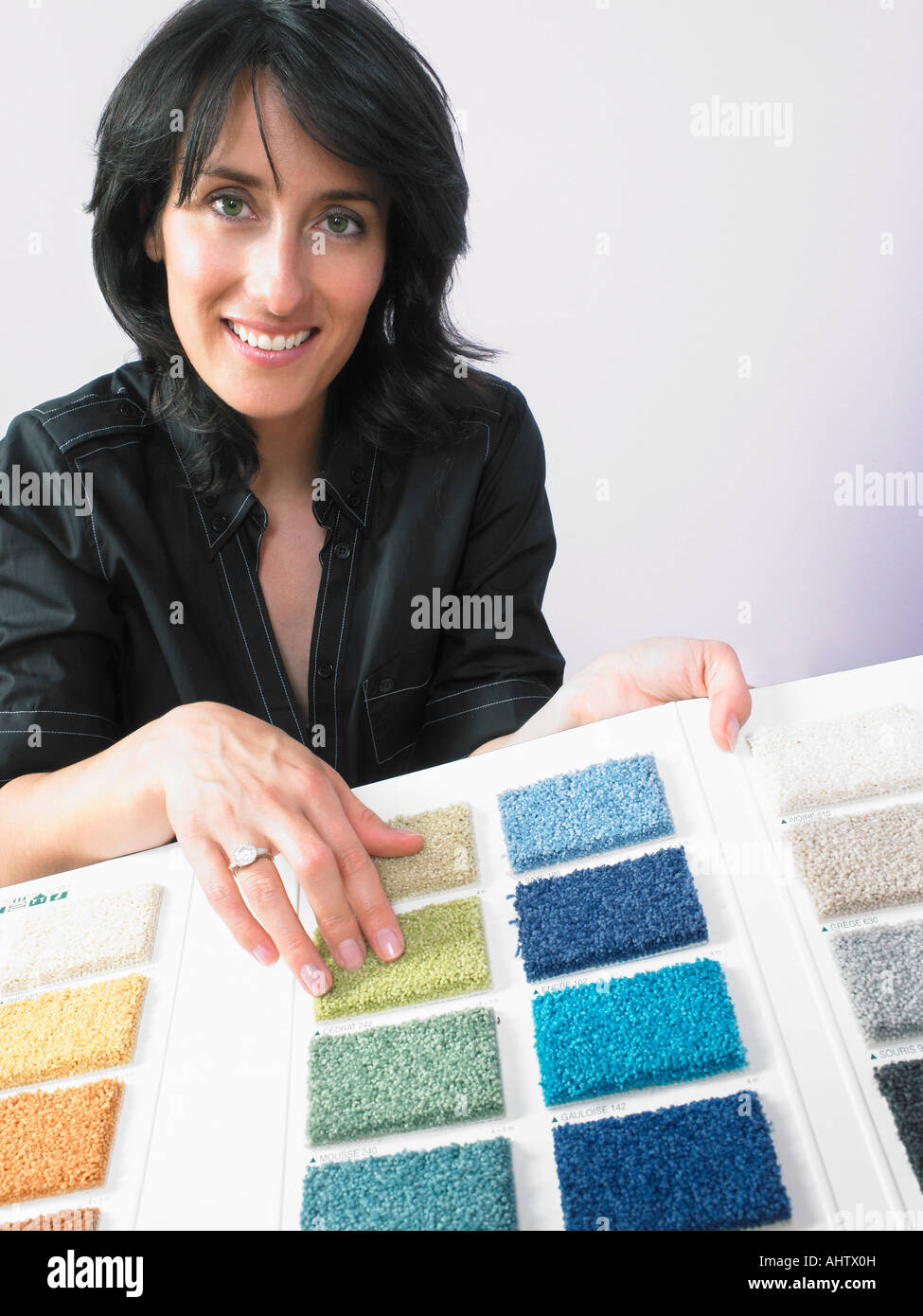 Designer showing carpet samples to camera Stock Photo - Alamy