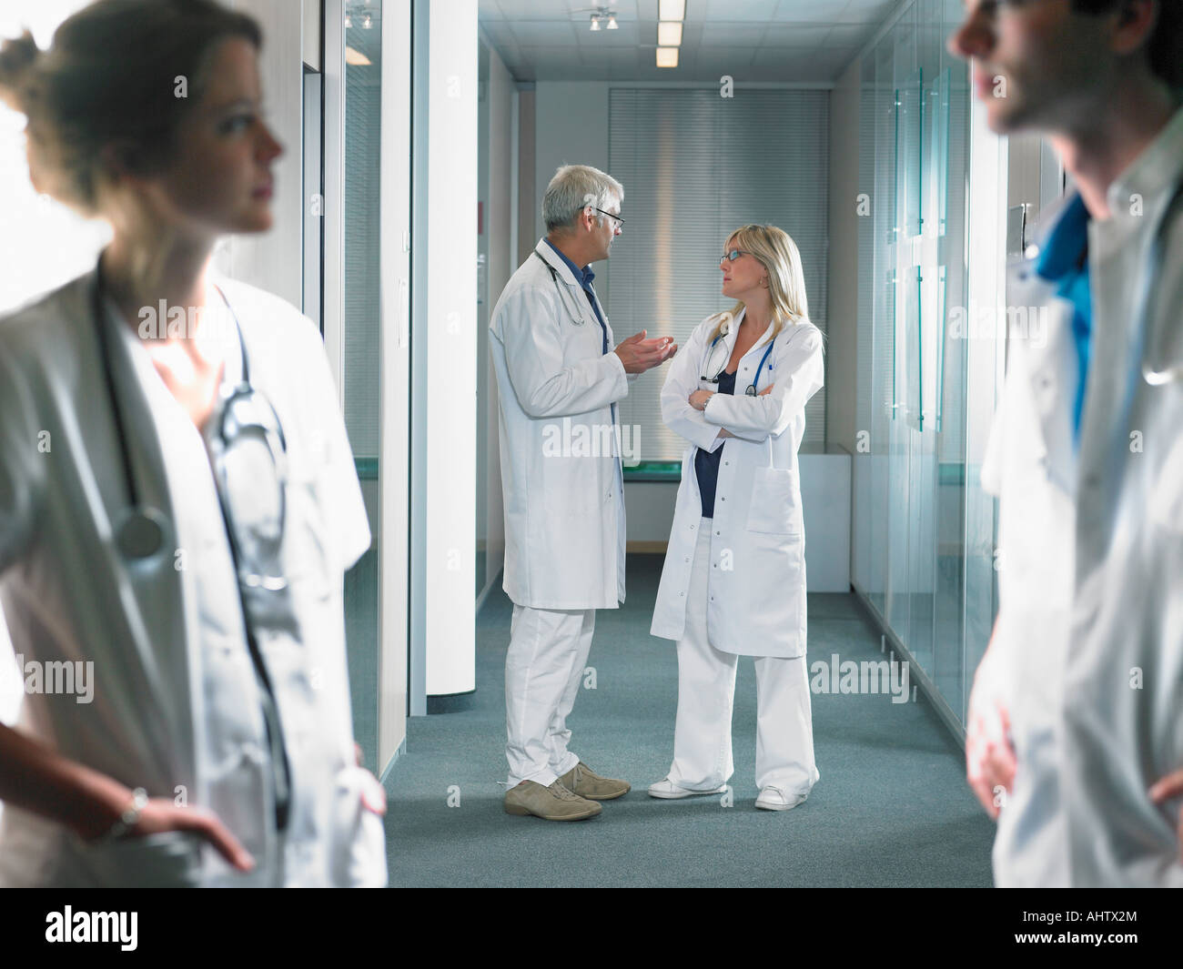 Group of doctors in discussion in hospital lobby Stock Photo - Alamy