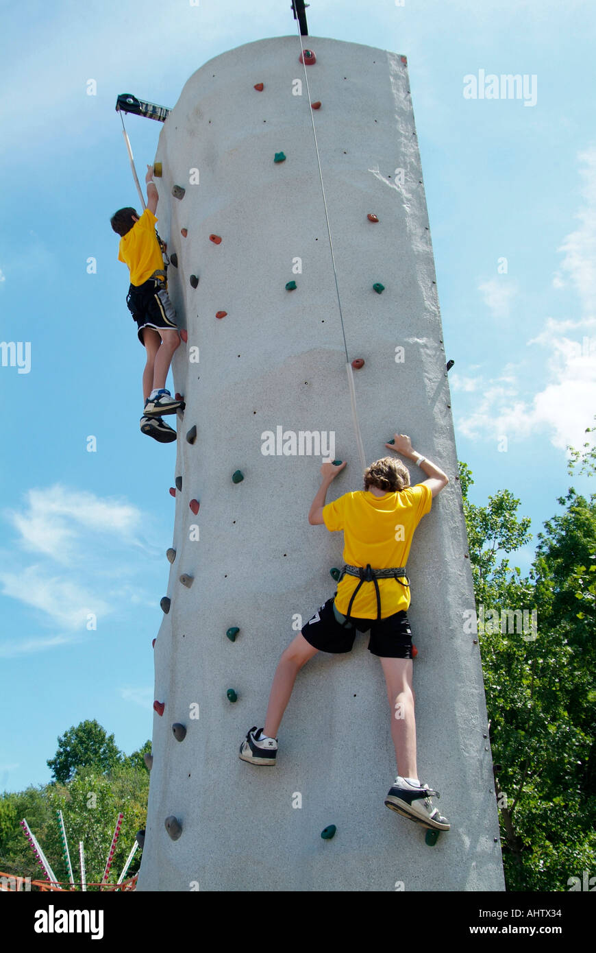 Two boys climb a rock wall Stock Photo - Alamy