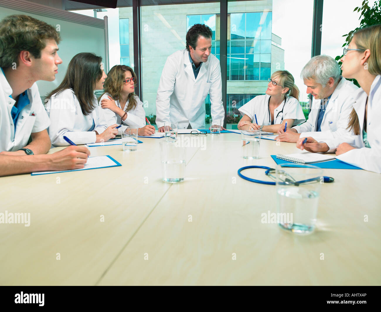 Business meeting of a group of doctors in a conference room around a ...