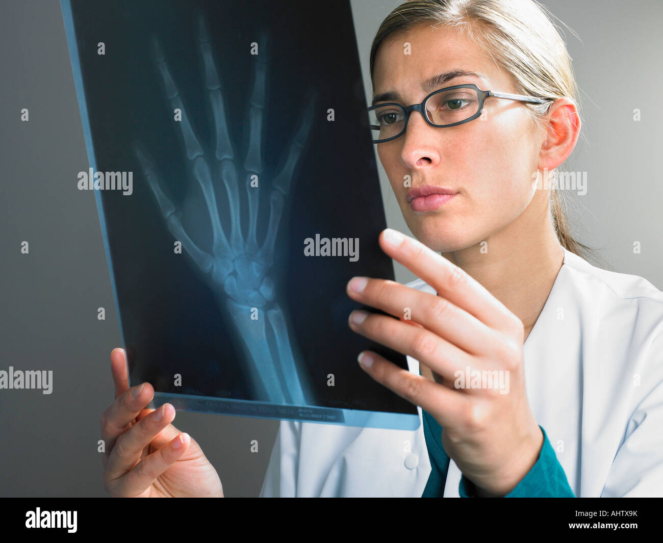 Female doctor looking at x ray of hand Stock Photo - Alamy