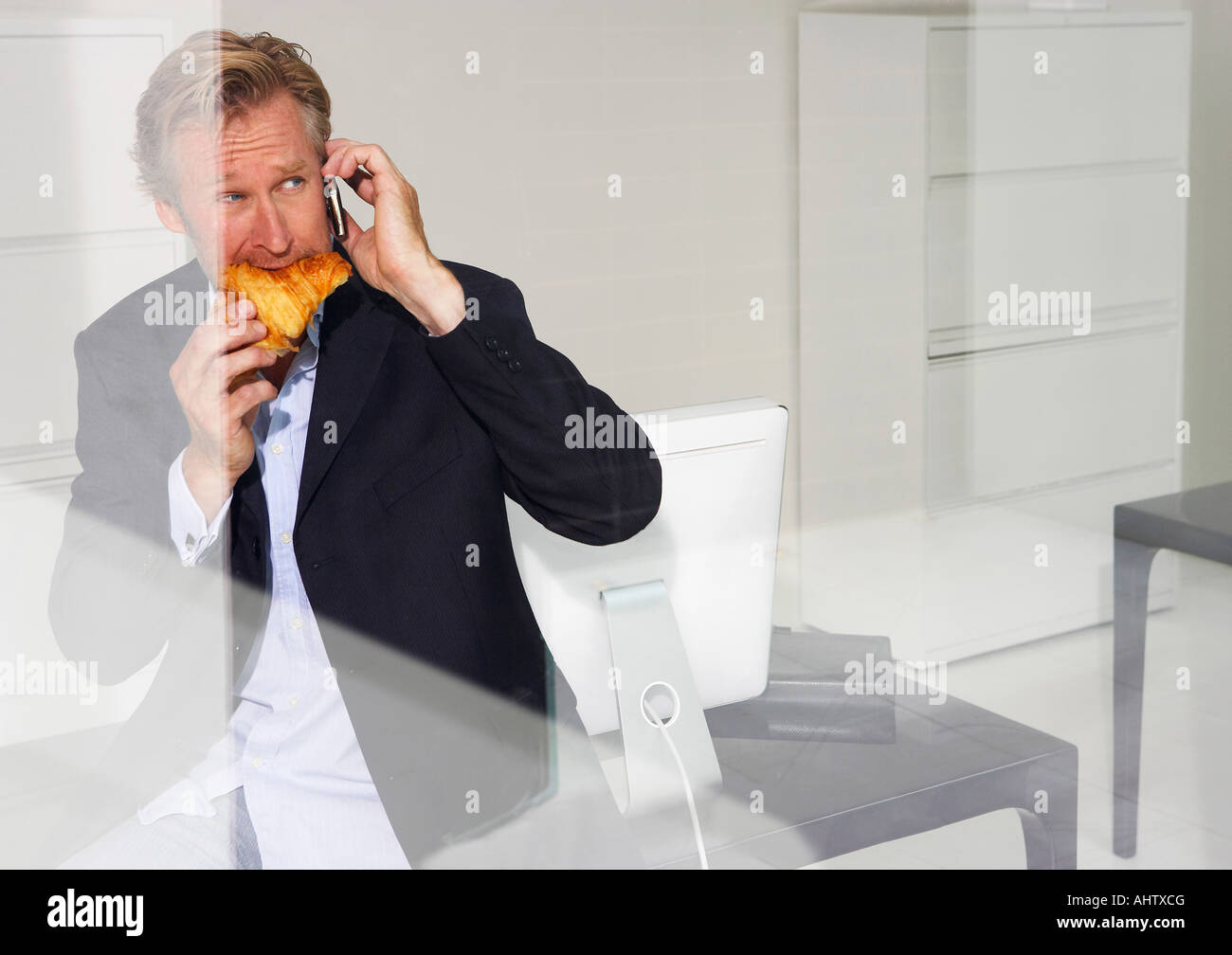 Eating pastry in the office hi-res stock photography and images - Alamy