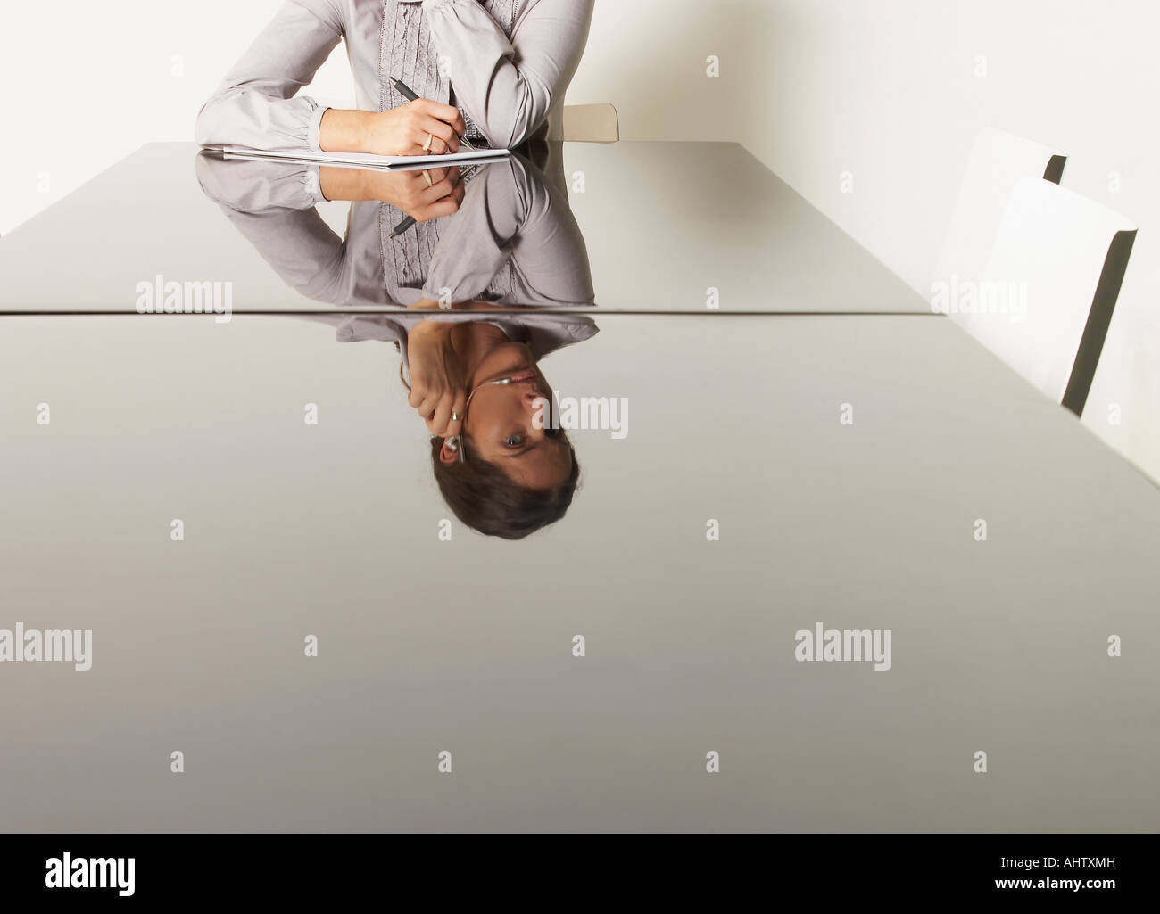 Young business woman at desk with reflections Stock Photo - Alamy