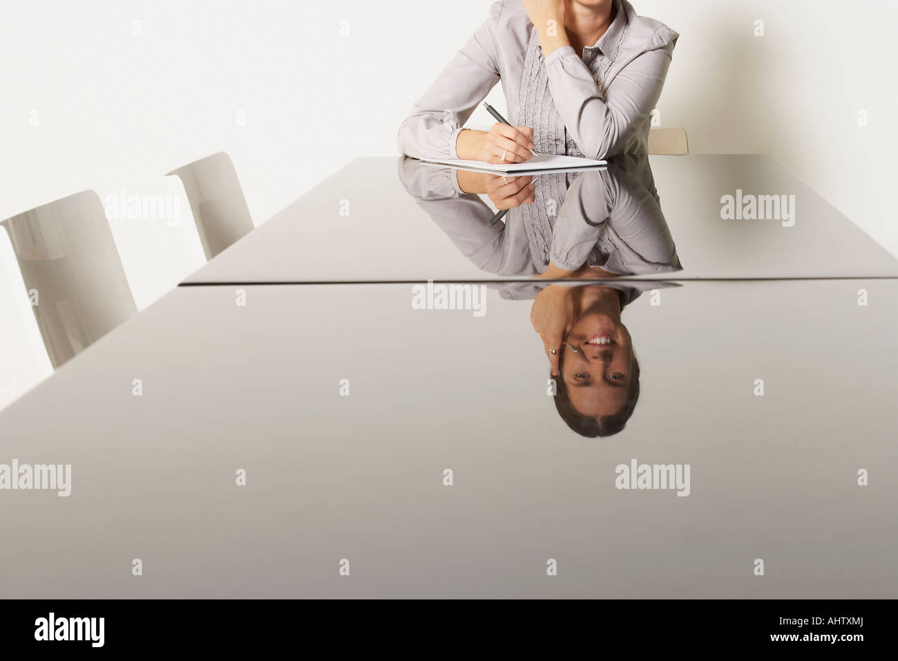 Young business woman at desk with reflections Stock Photo - Alamy