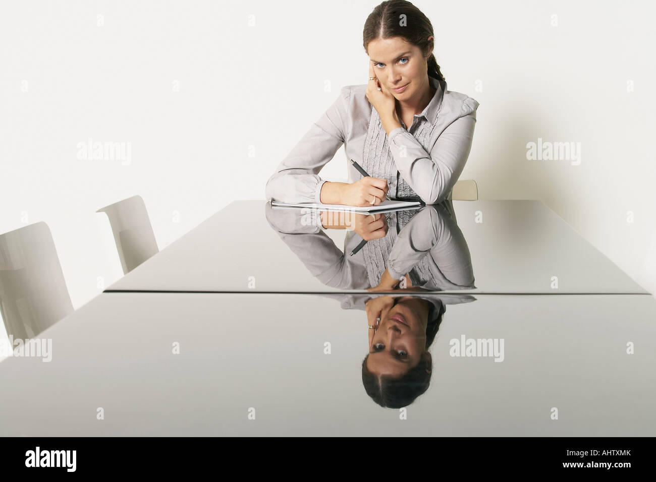 Young business woman at desk with reflections Stock Photo - Alamy