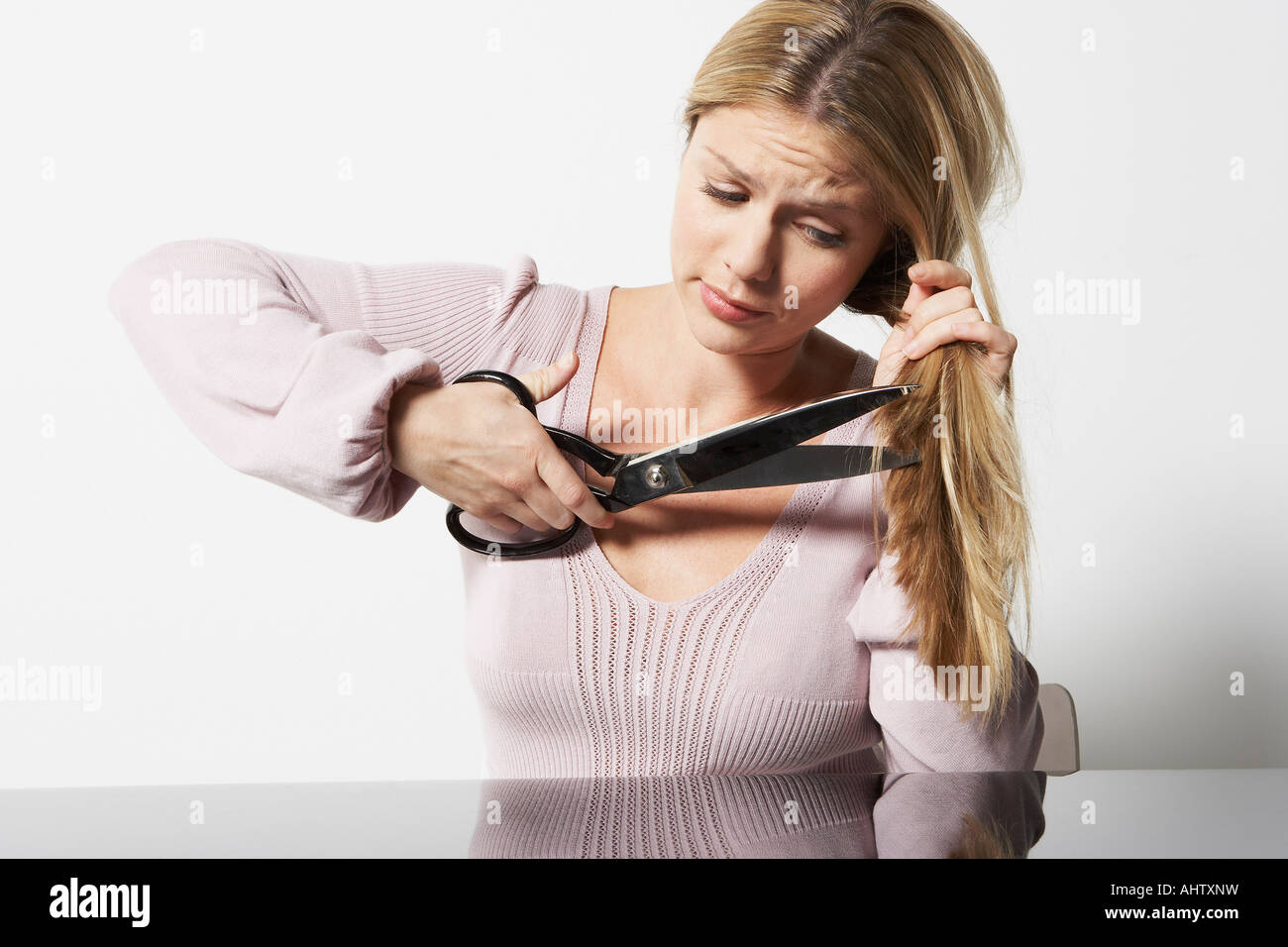 Woman cutting own hair with scissors Stock Photo - Alamy Woman cutting own hair with scissors Stock Photo - Alamy