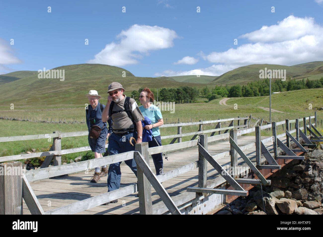 Glen Isla Walkers crossing the timber bridge over the River Isla Angus ...