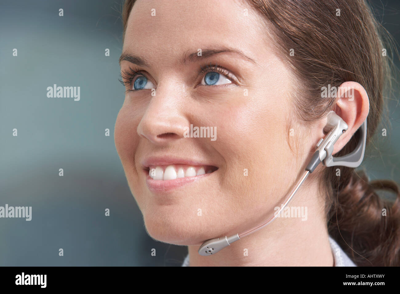 Close-Up portrait of Business woman using telephone headset / earpiece ...