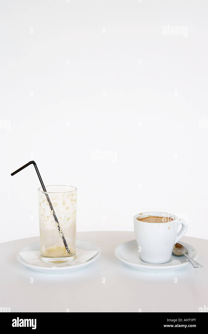 Empty glass with straw and cup of expresso Stock Photo - Alamy