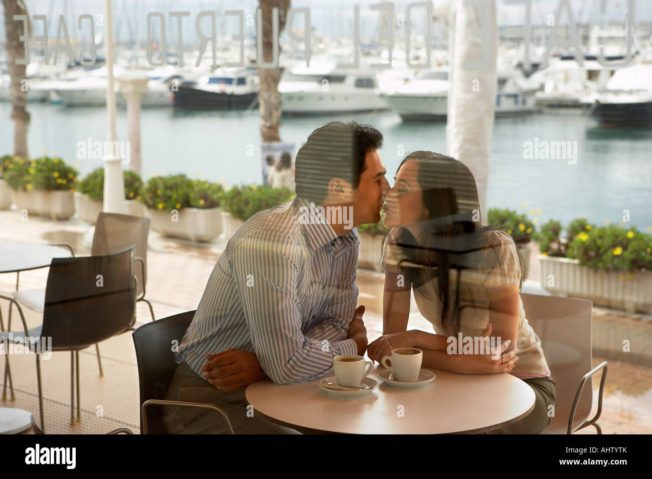 Couple being affectionate in a restaurant Stock Photo - Alamy