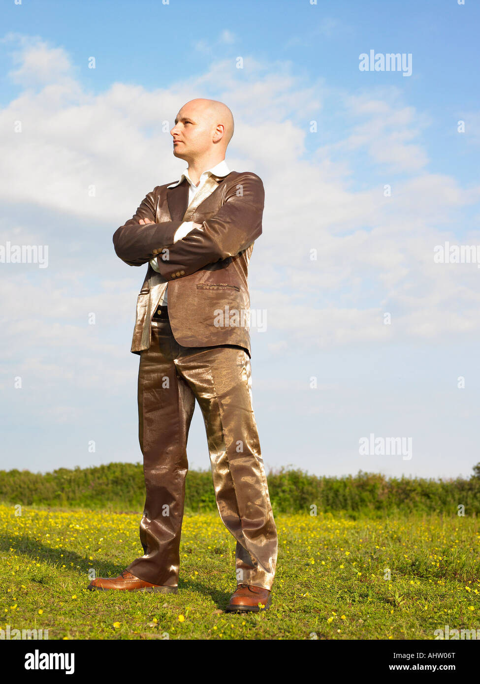 Man in gold suit standing in field Stock Photo - Alamy