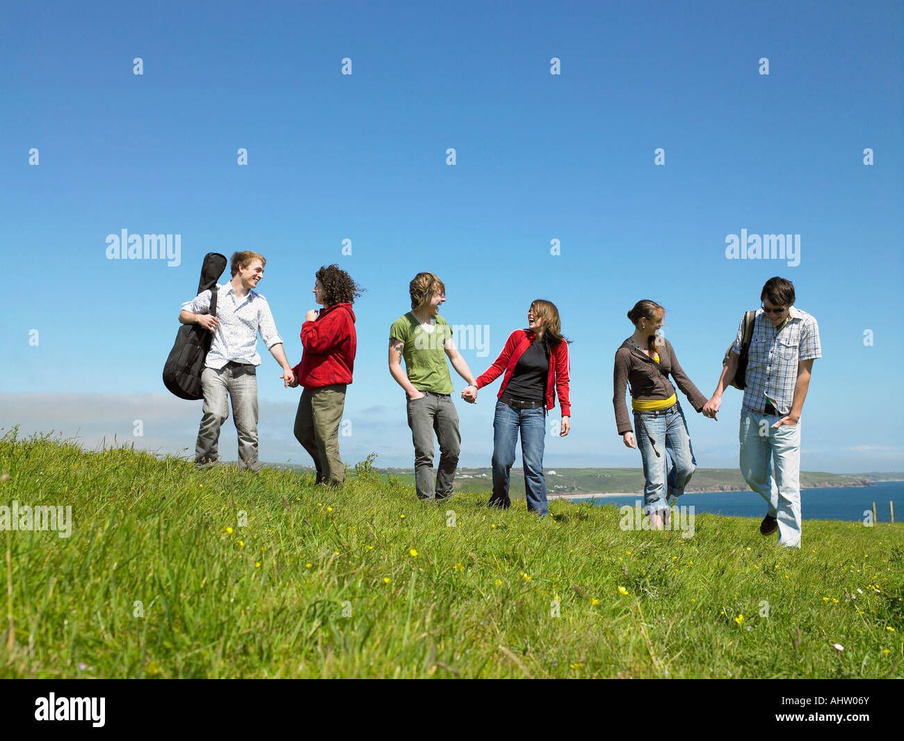 Three young couples holding hands Stock Photo - Alamy