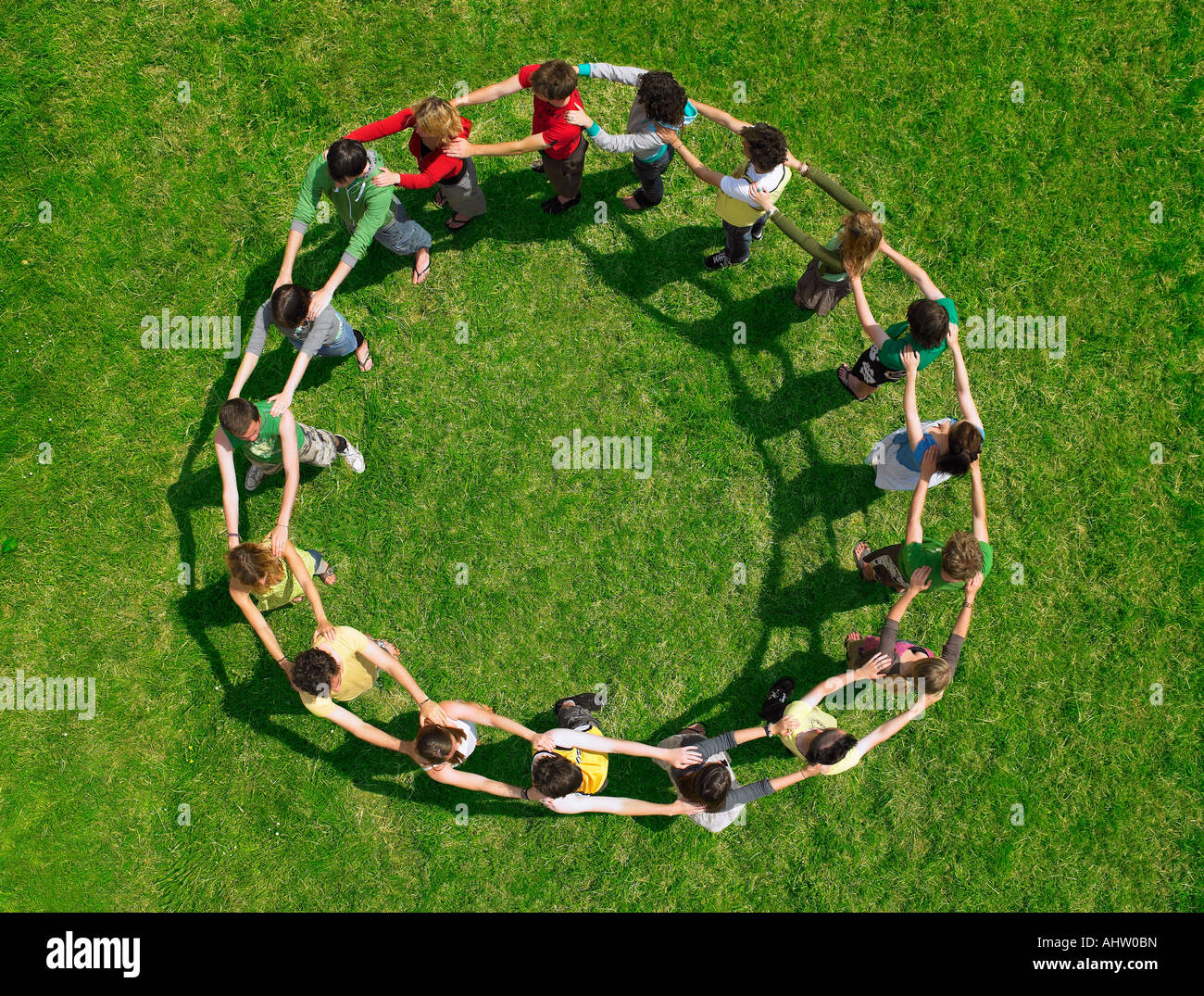 Group standing joined in a circle Stock Photo - Alamy