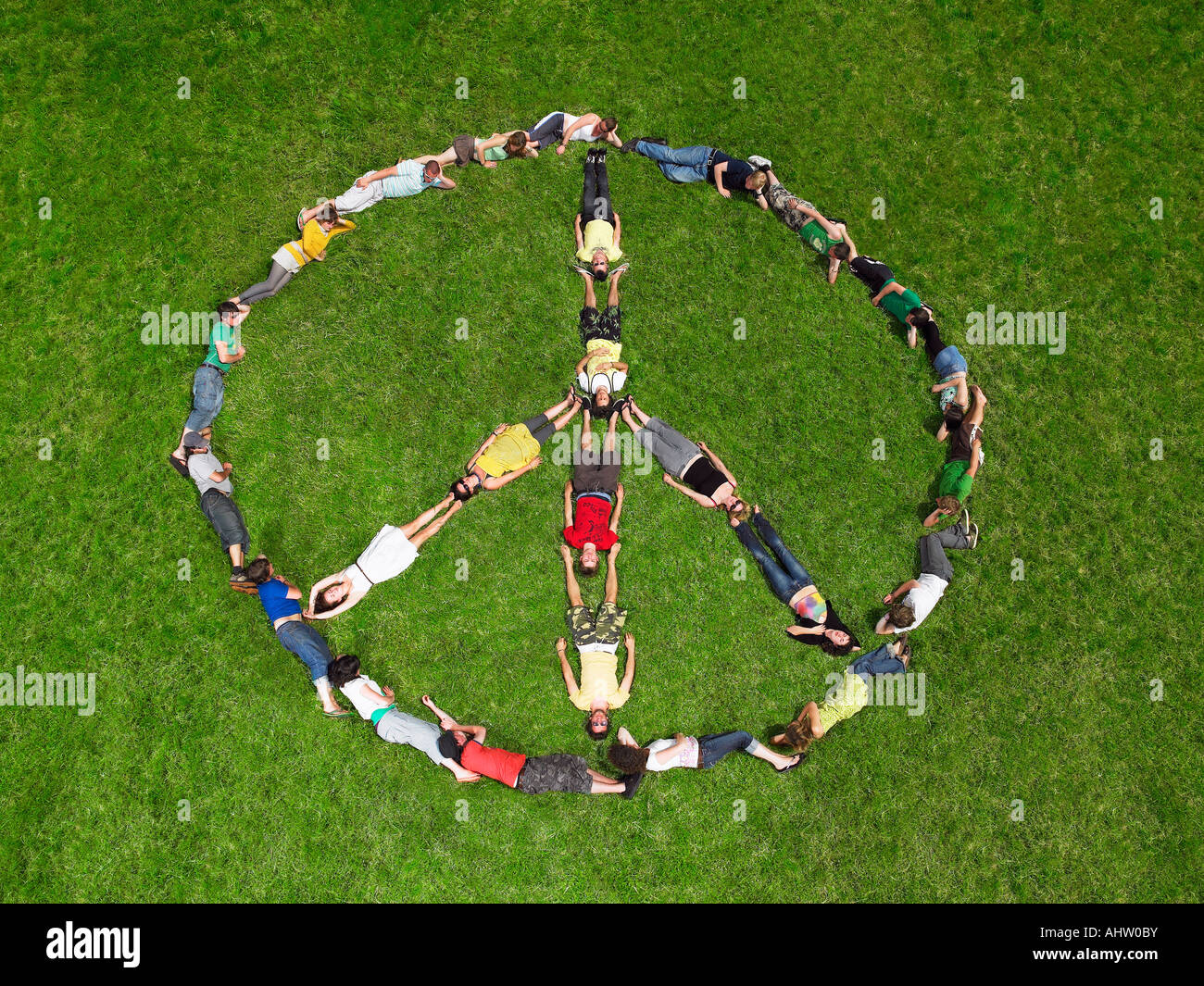 Group lying on grass in a peace sign formation Stock Photo - Alamy