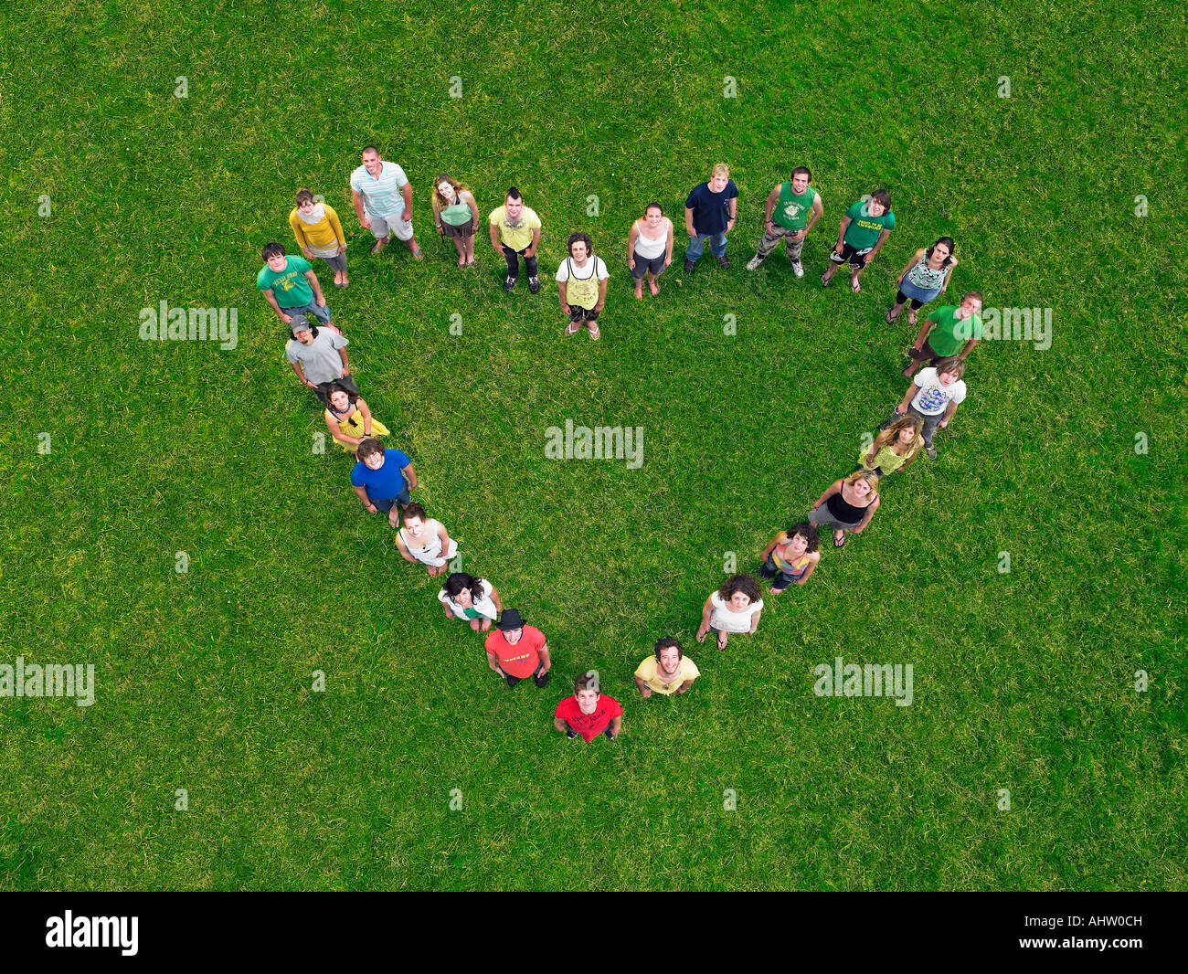 Group standing on grass in heart shape formation Stock Photo - Alamy