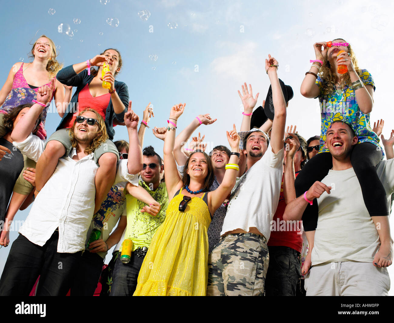 Crowd of young people cheering and waving Stock Photo - Alamy