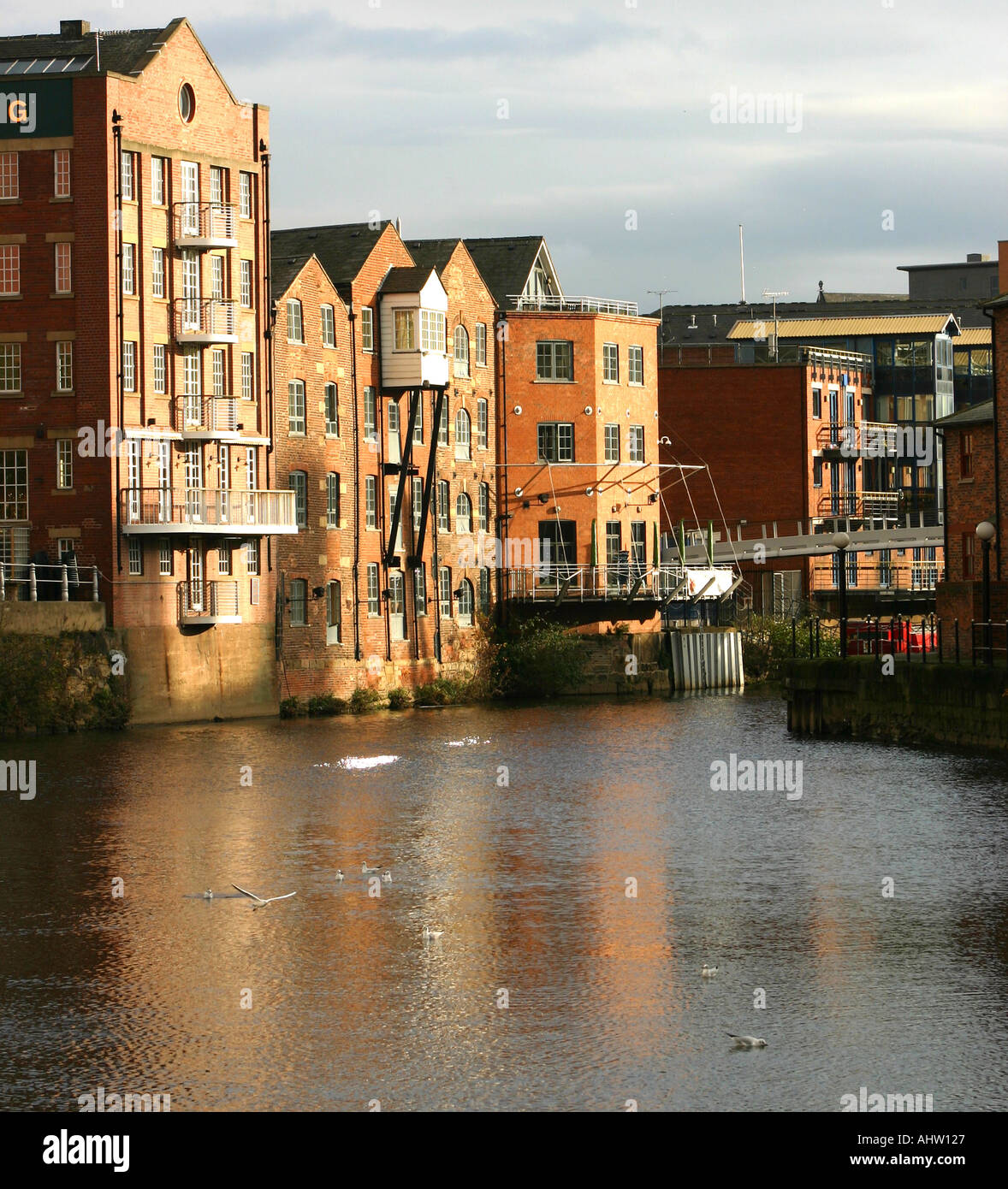 River Aire Leeds city centre with regenerated industrial warehouses in ...