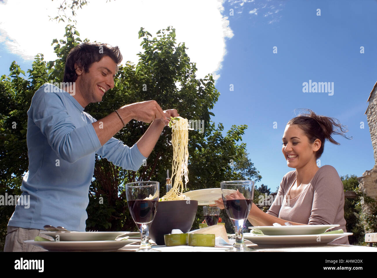 Young couple eating pasta Stock Photo - Alamy