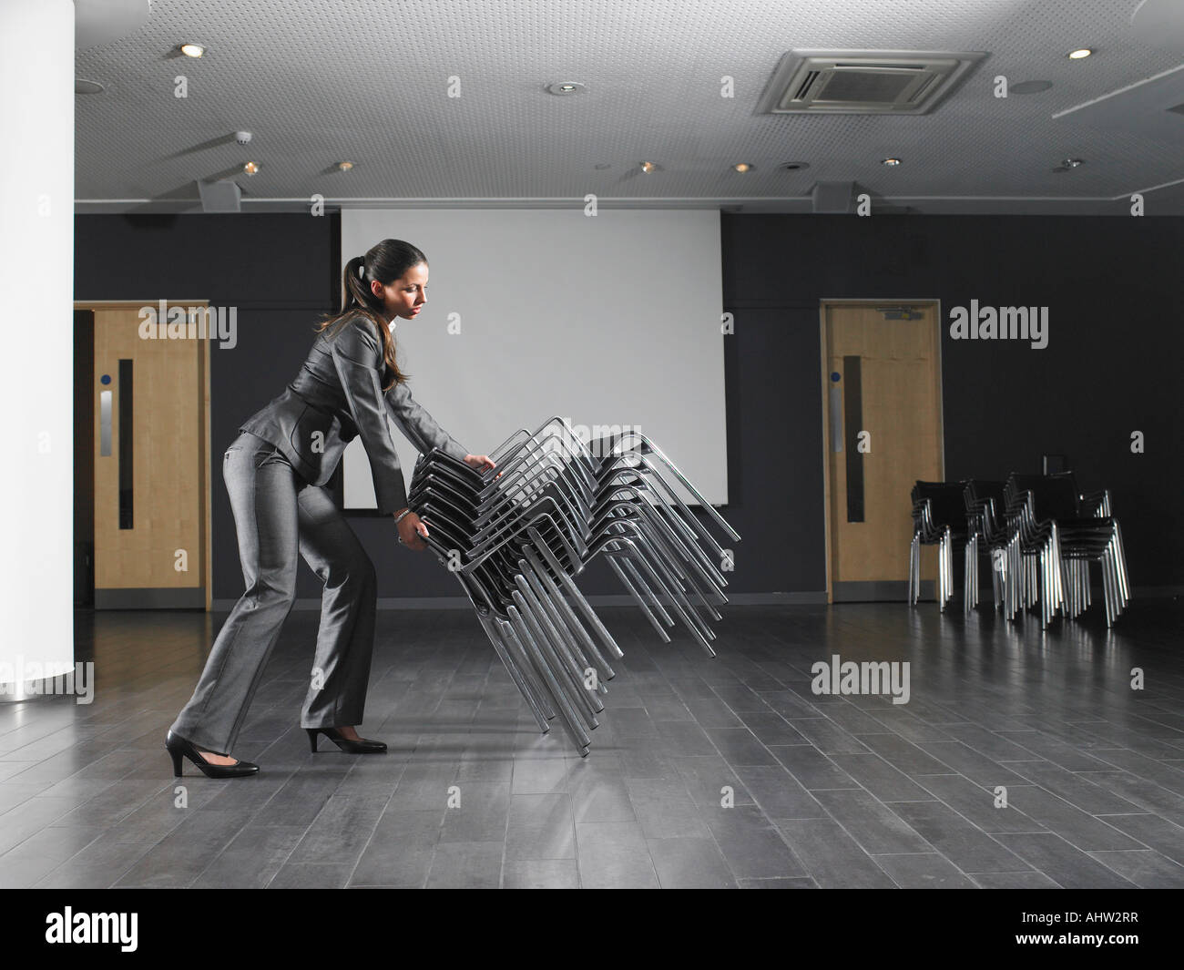 Woman standing empty chairs hi-res stock photography and images - Alamy