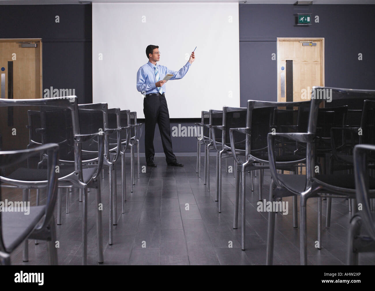 Man practicing speech in empty presentation room Stock Photo - Alamy