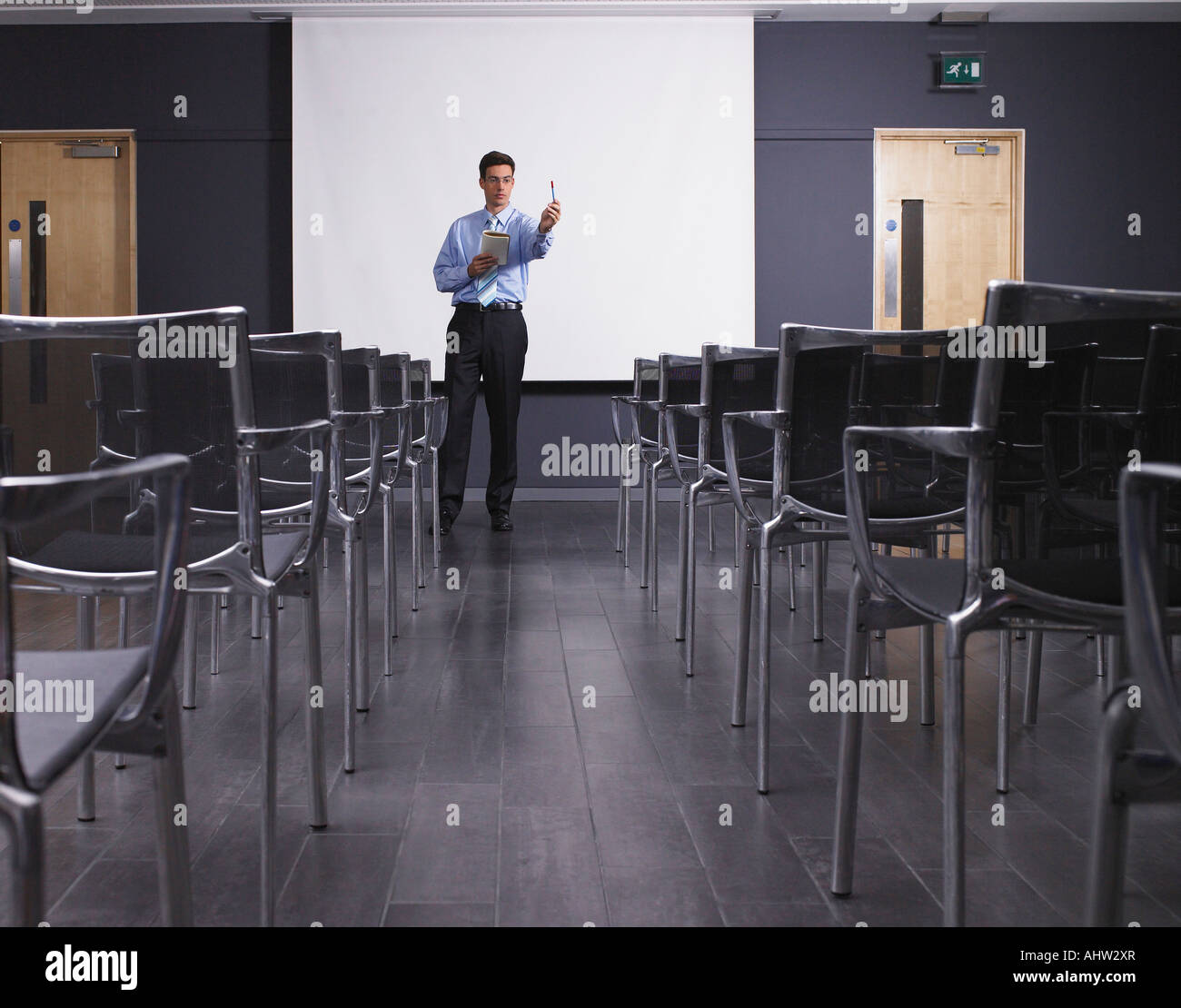 Man practicing speech in empty presentation room Stock Photo - Alamy