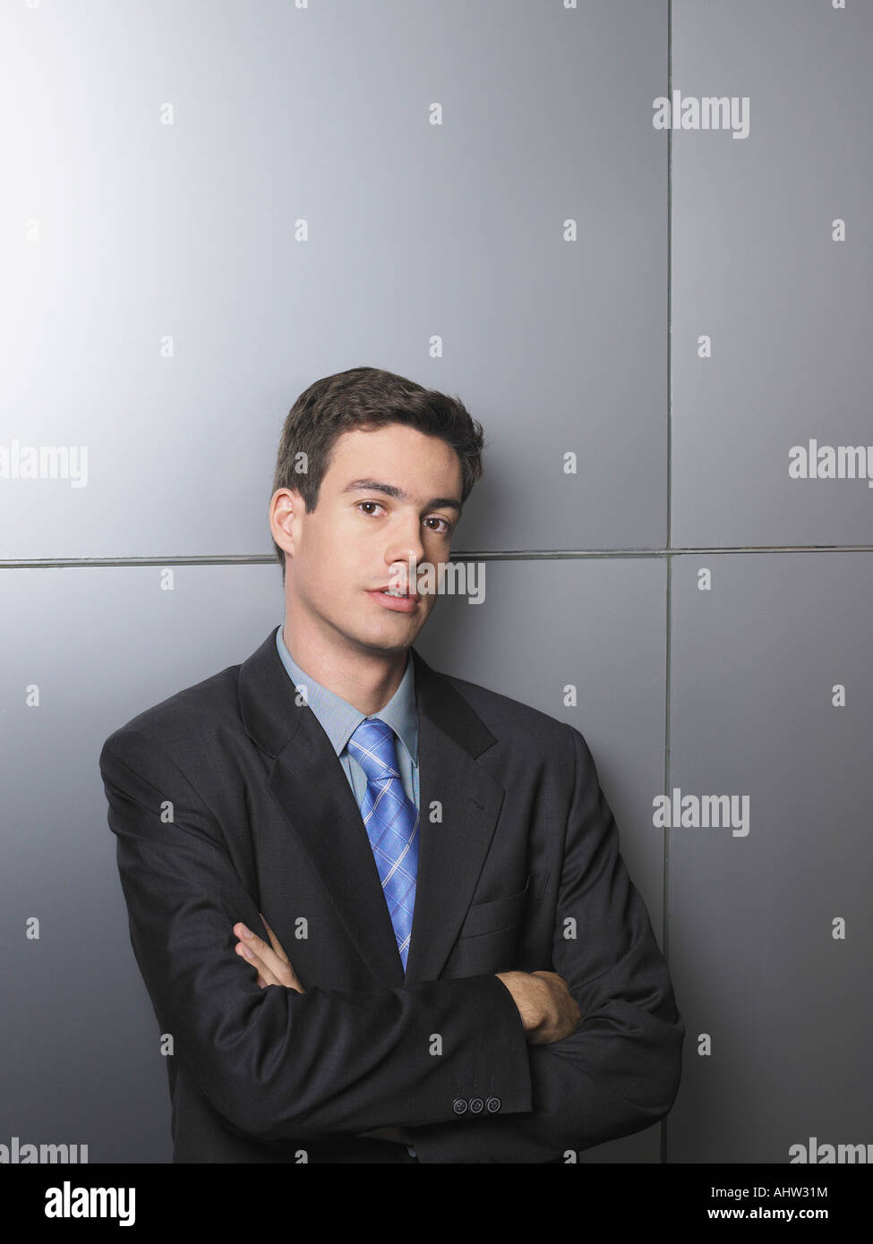 Businessman standing in front of a white wall Stock Photo - Alamy