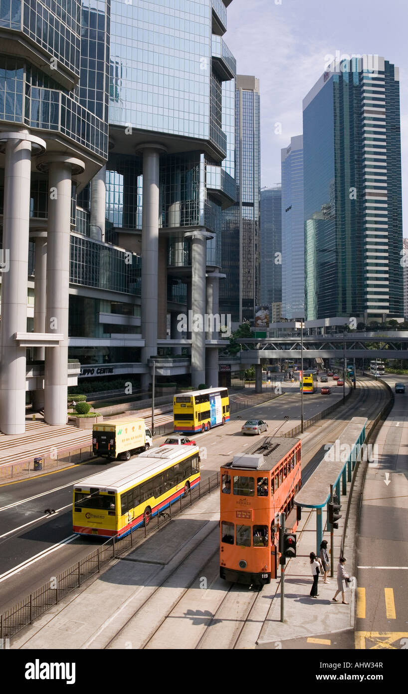 Trams and buses in between the city skyscrapers of hong kong , china ...
