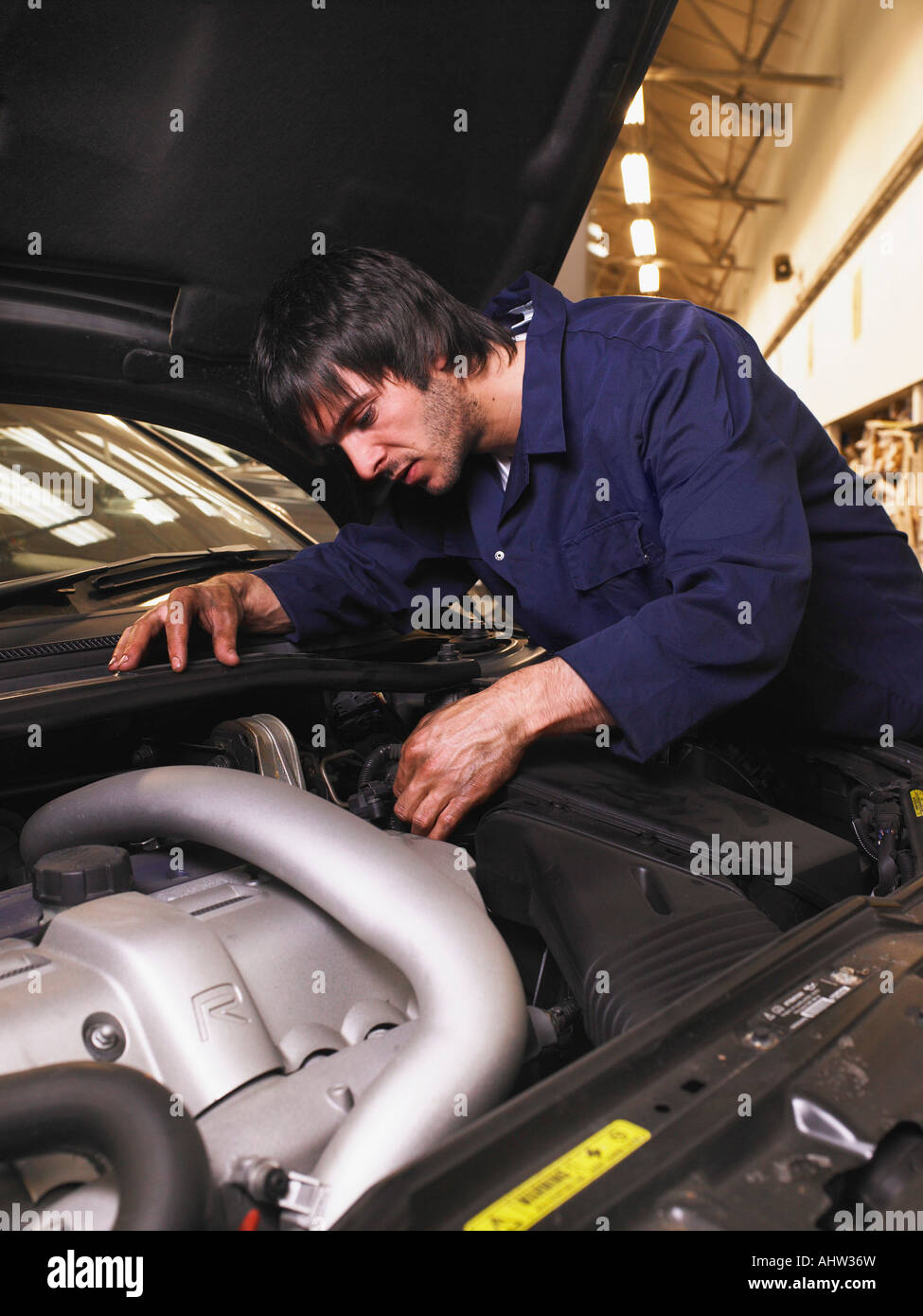 Mechanic working on an engine Stock Photo - Alamy