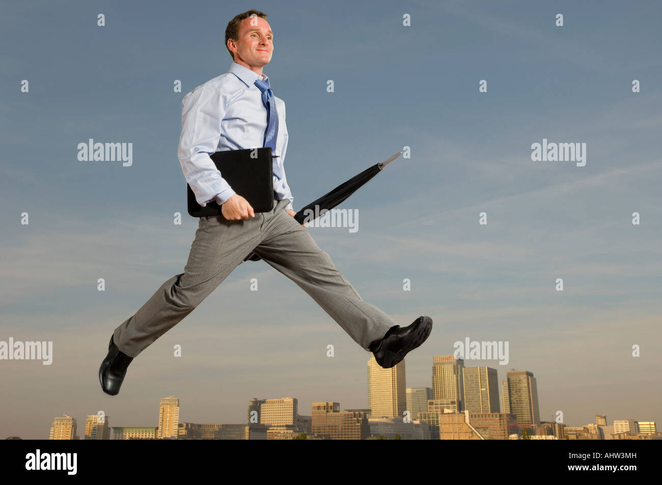 Business man striding across city skyline Stock Photo - Alamy