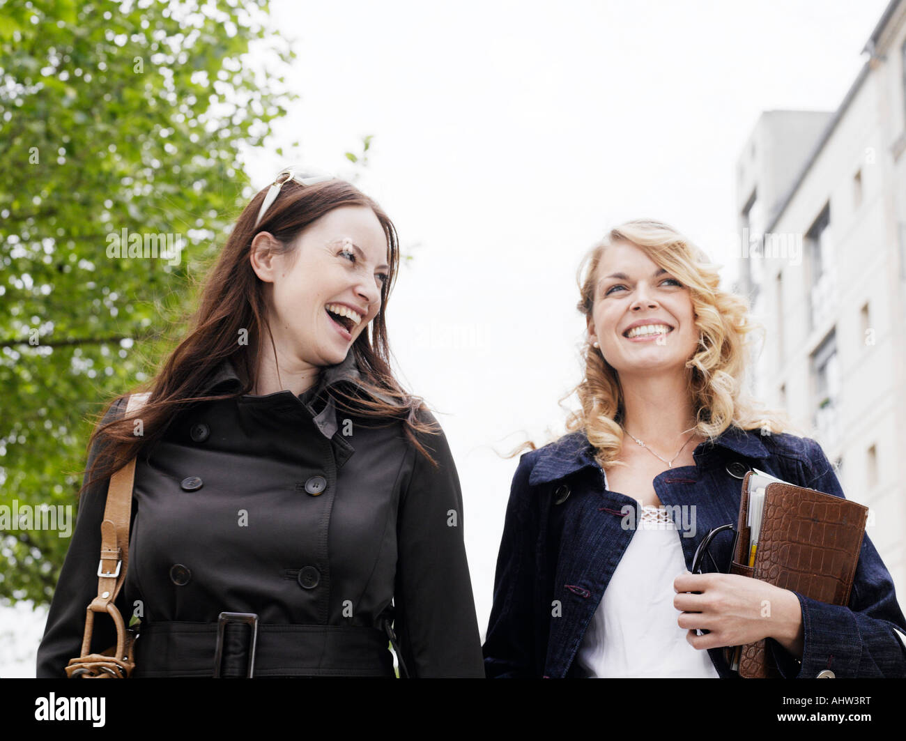 Two women laughing outdoors Stock Photo - Alamy