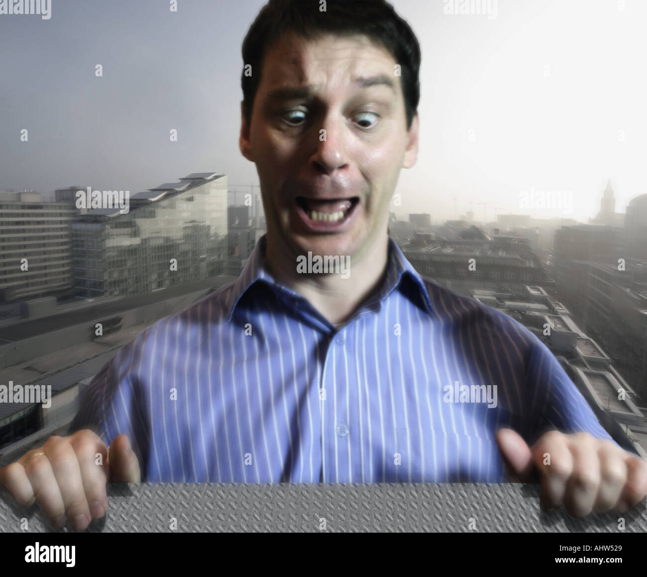 Composite showing man hanging on for dear life Stock Photo - Alamy