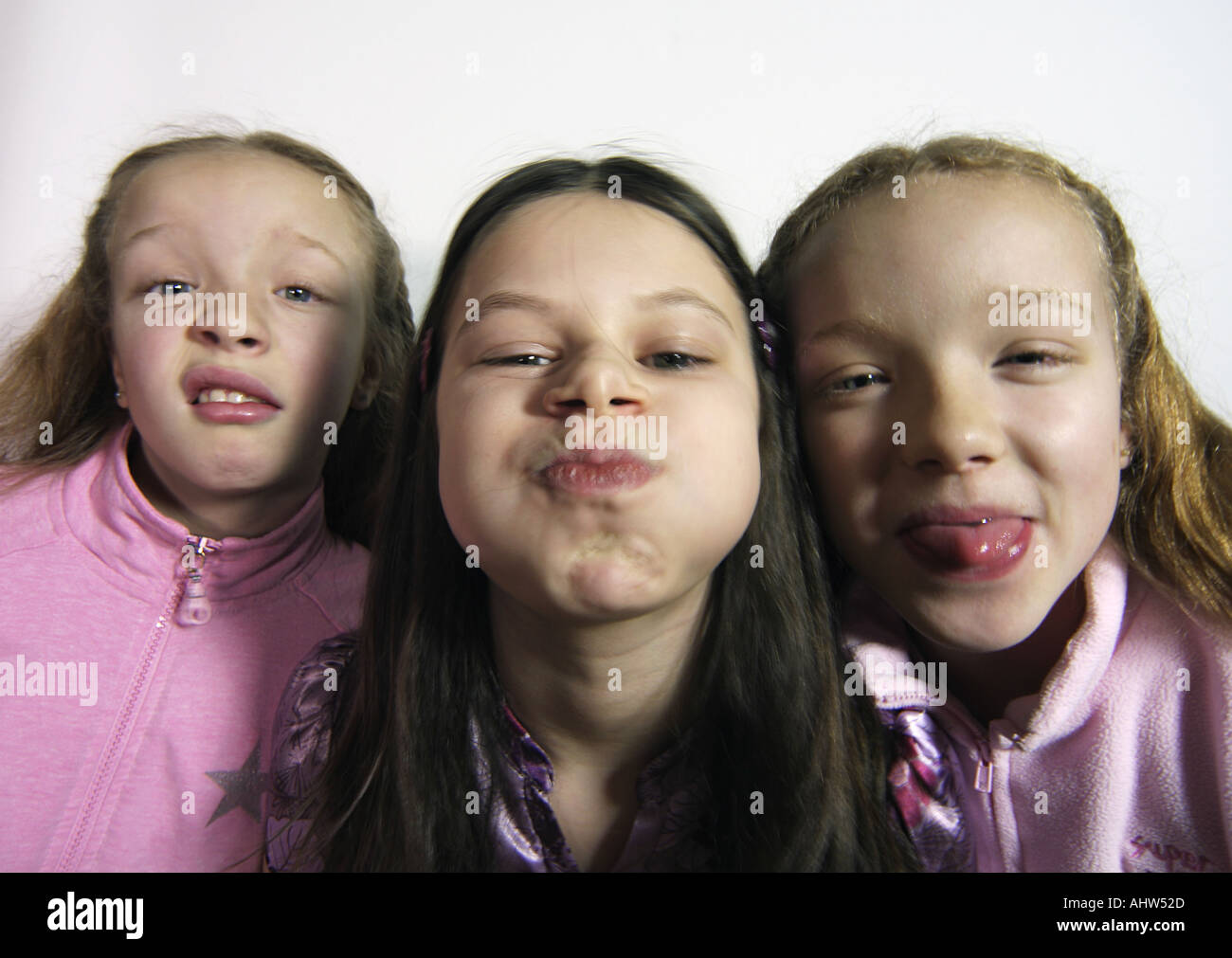 Three girls pull faces Stock Photo - Alamy