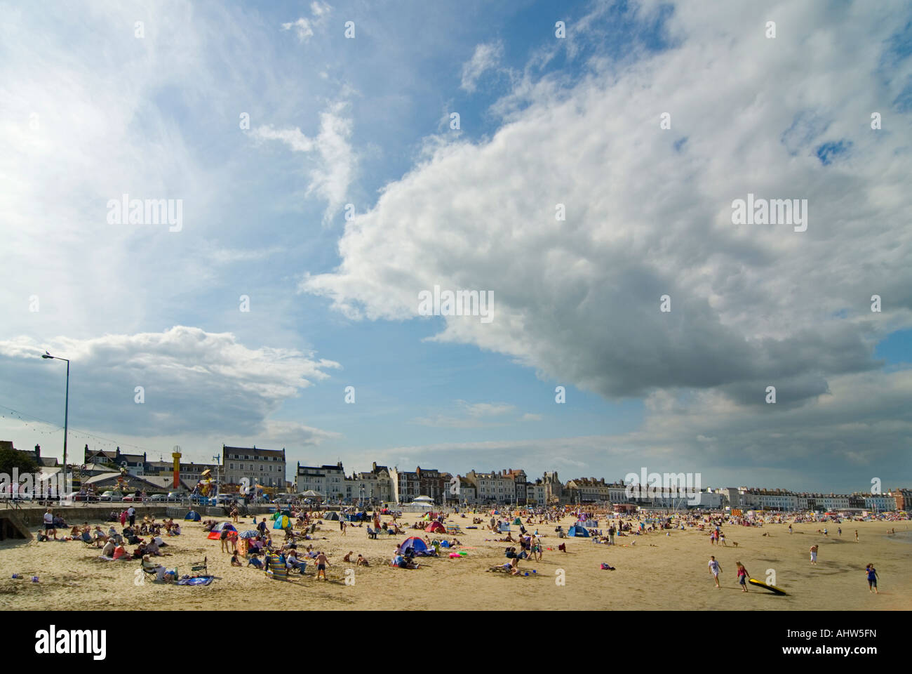 Horizontal wide angle of a typical English beach scene with lots of ...