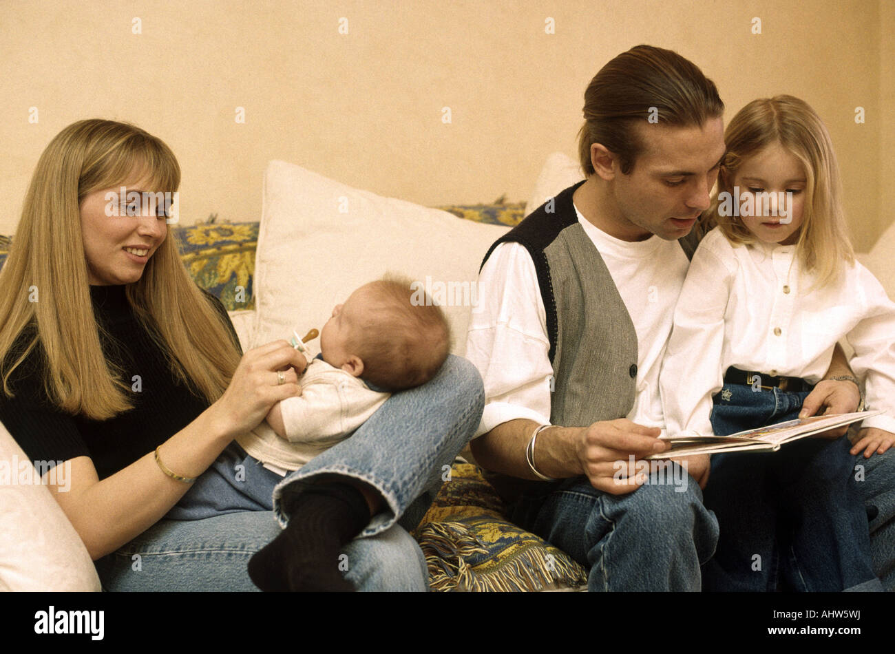 Family relaxing together in their lounge Stock Photo - Alamy