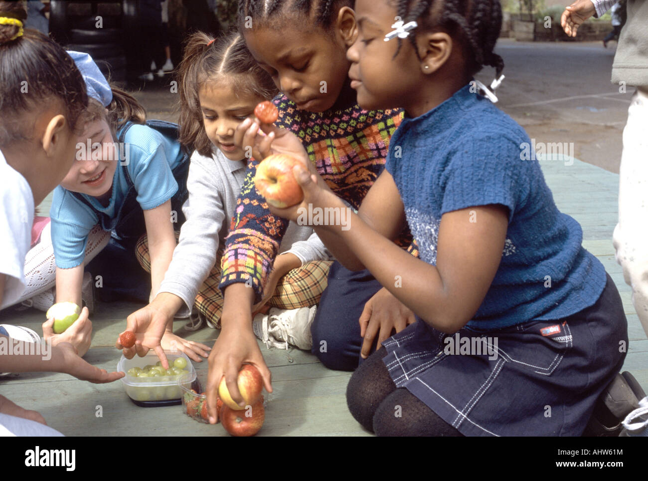 six year old children in school playground eating fruit Stock Photo - Alamy