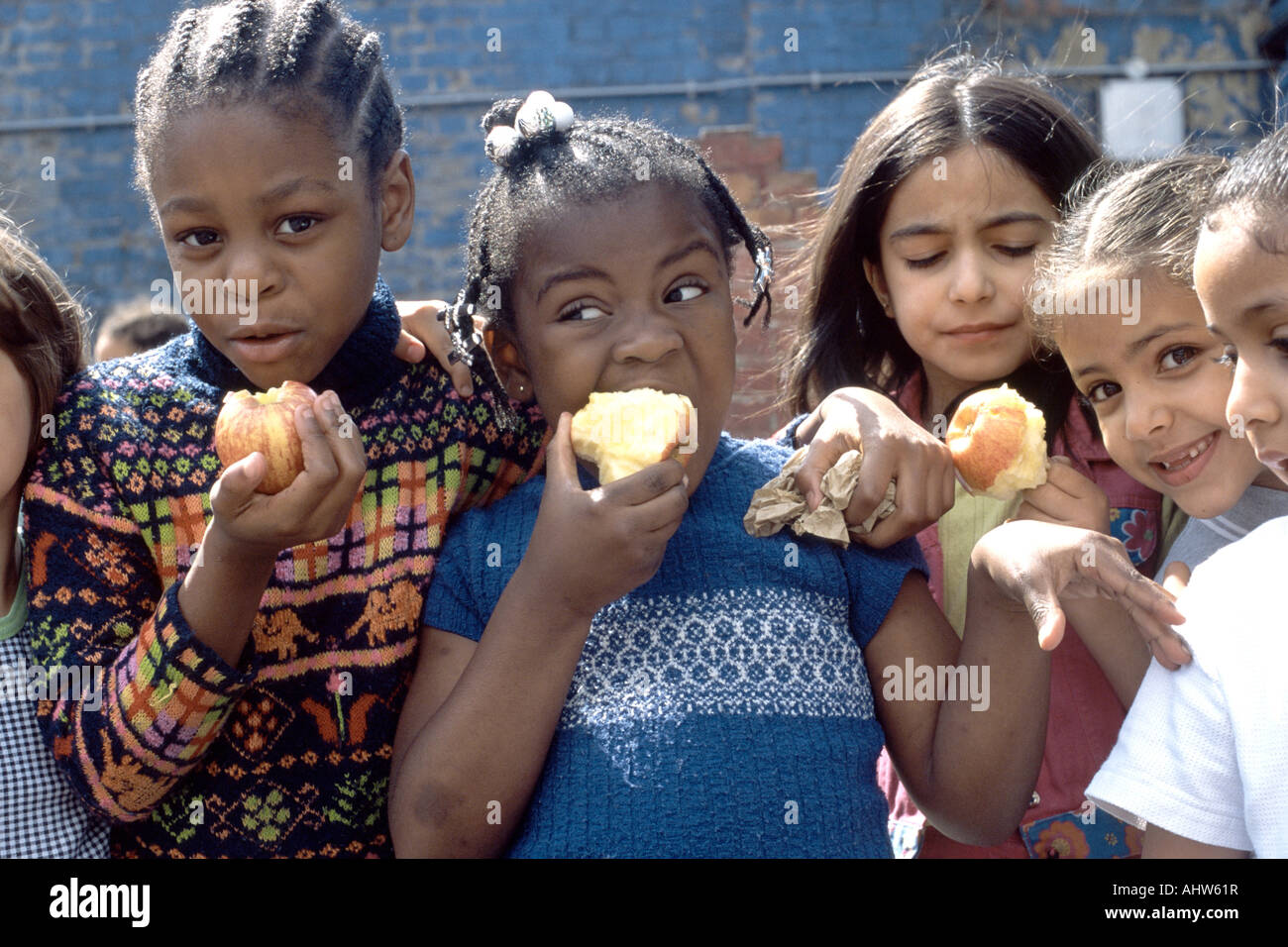 group of young children eating fruit in school playground Stock Photo ...